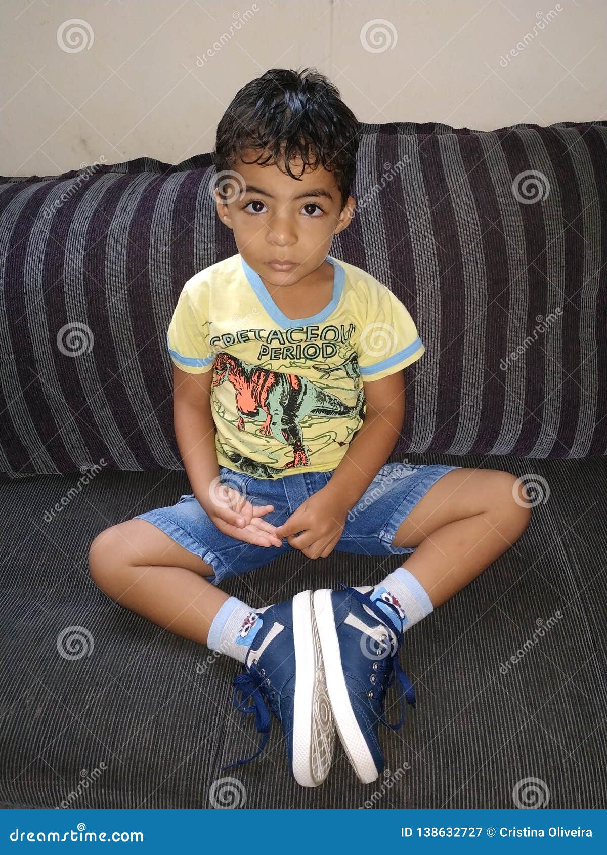Boy sitting on the sofa stock image. Image of child - 138632727