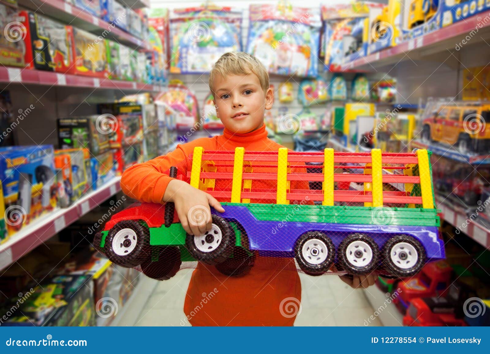 Boy in shop with toy truck stock photo. Image of children - 12278554