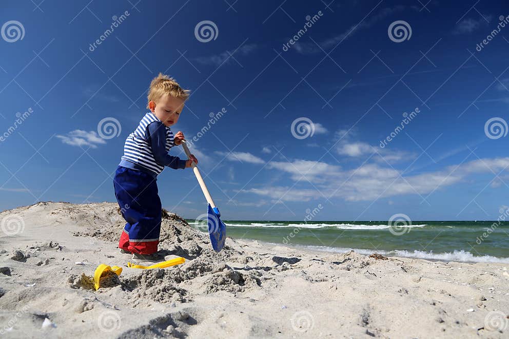 Boy with a Shovel at the Beach Stock Image - Image of heat, interest ...