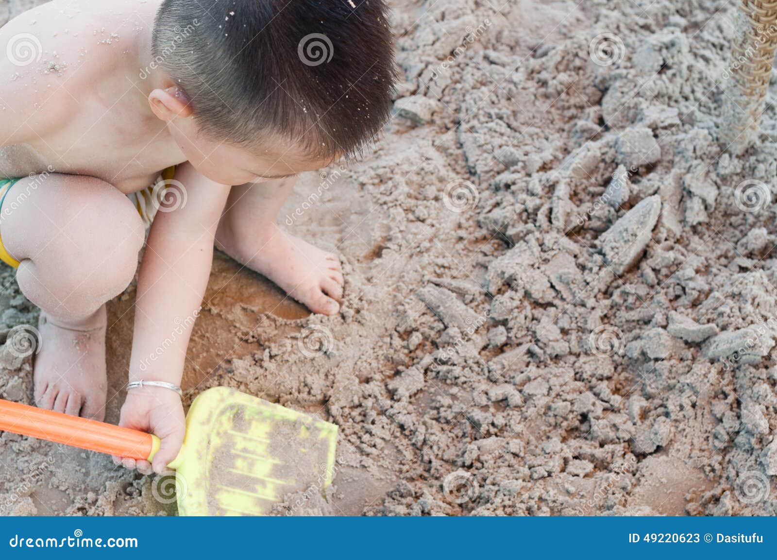 Boy shoveling sands stock image. Image of horizontal - 49220623
