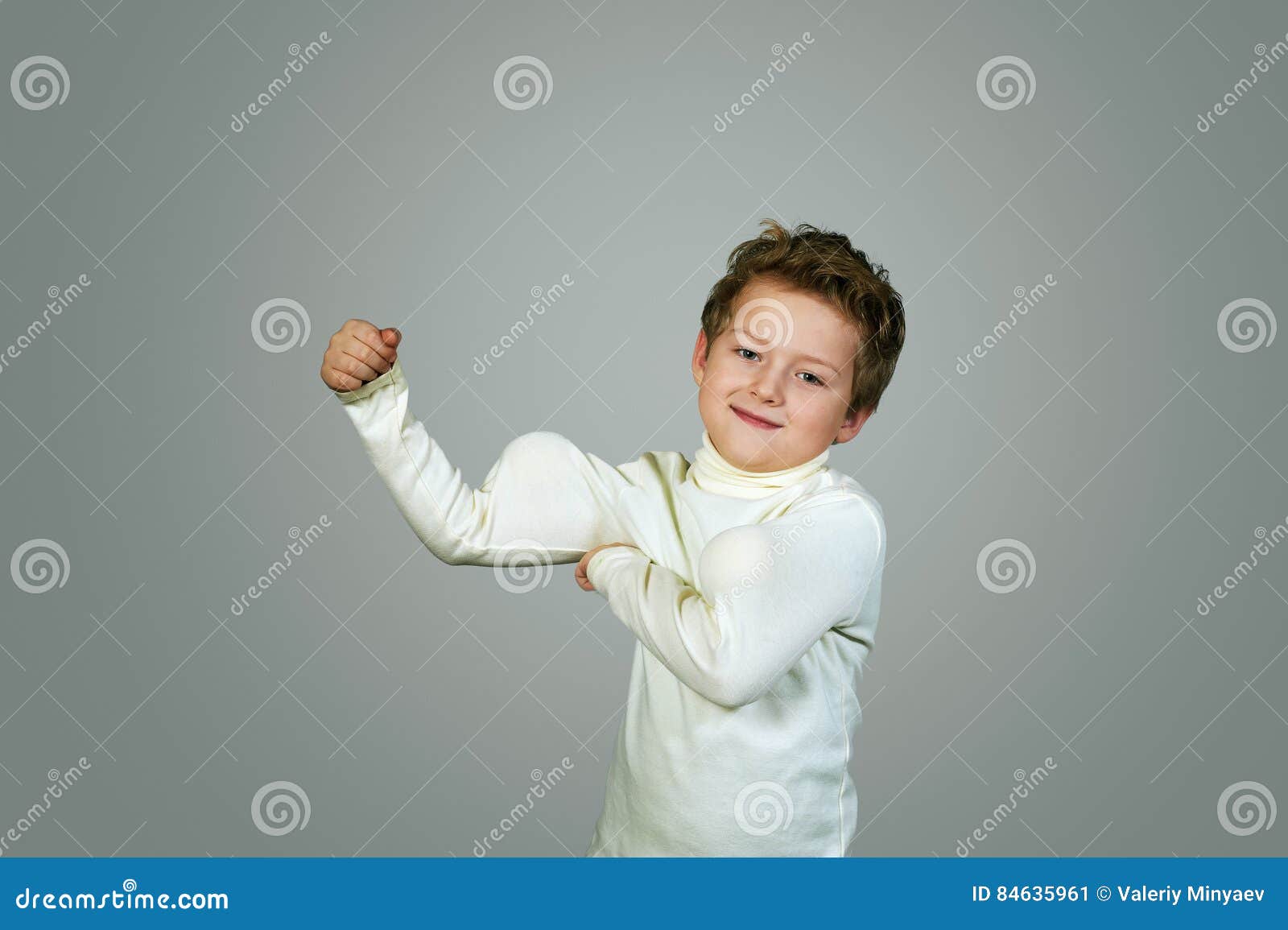 The boy shows his strength stock image. Image of biceps - 84635961