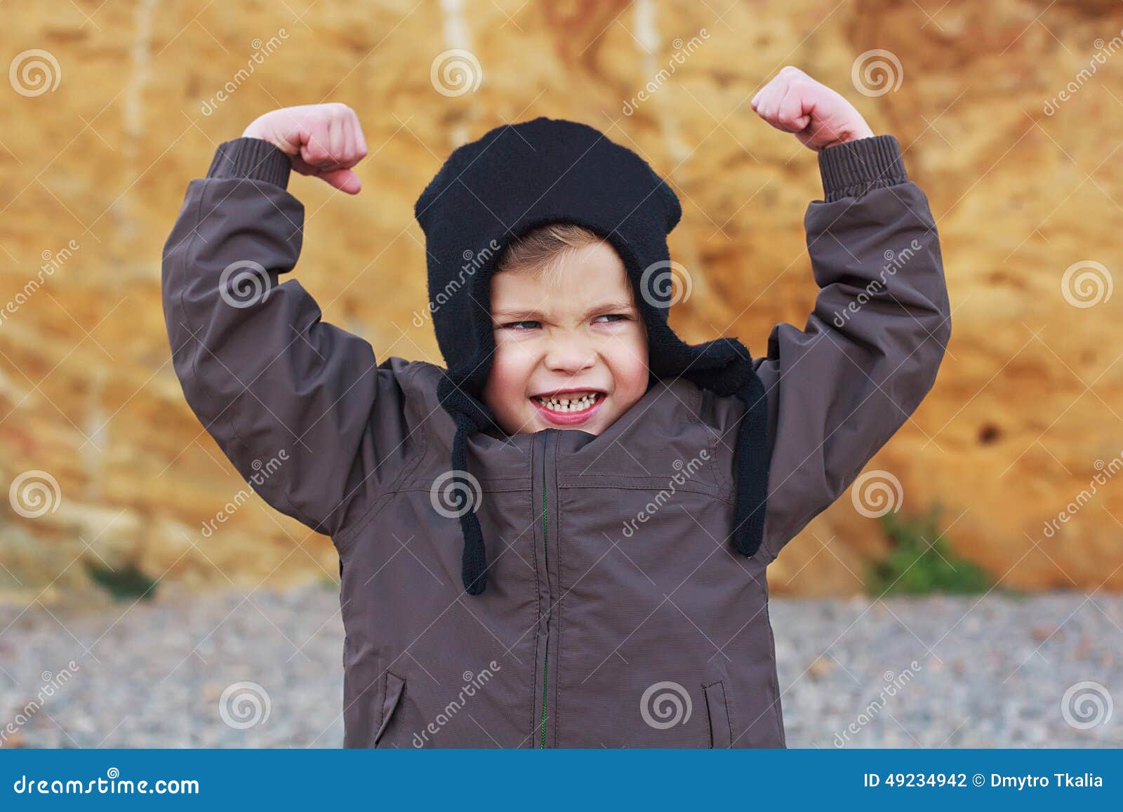Boy Shows Power and Strenth Stock Photo - Image of clothes, jacket ...