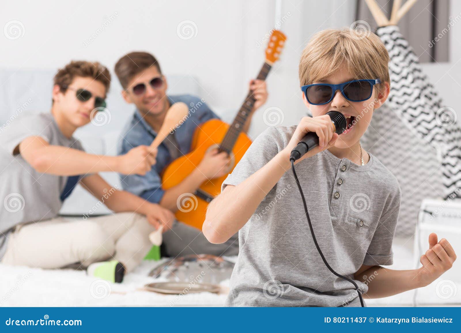Boy singing to microphone stock image. Image of father - 80211437