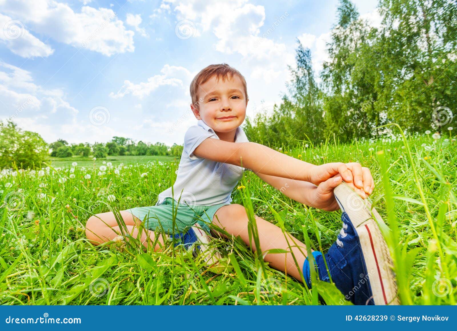 Boy Sit on a Grass and Does Gymnastics Stock Image - Image of hands ...