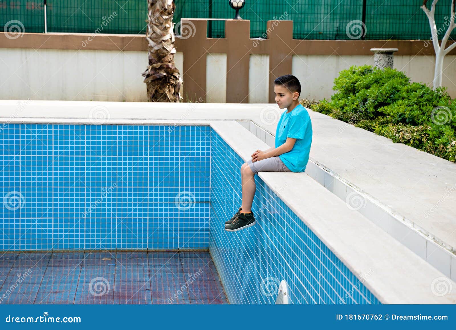 A Boy Sits by an Empty Pool. Concept Summer 2020. No Tourism Stock ...