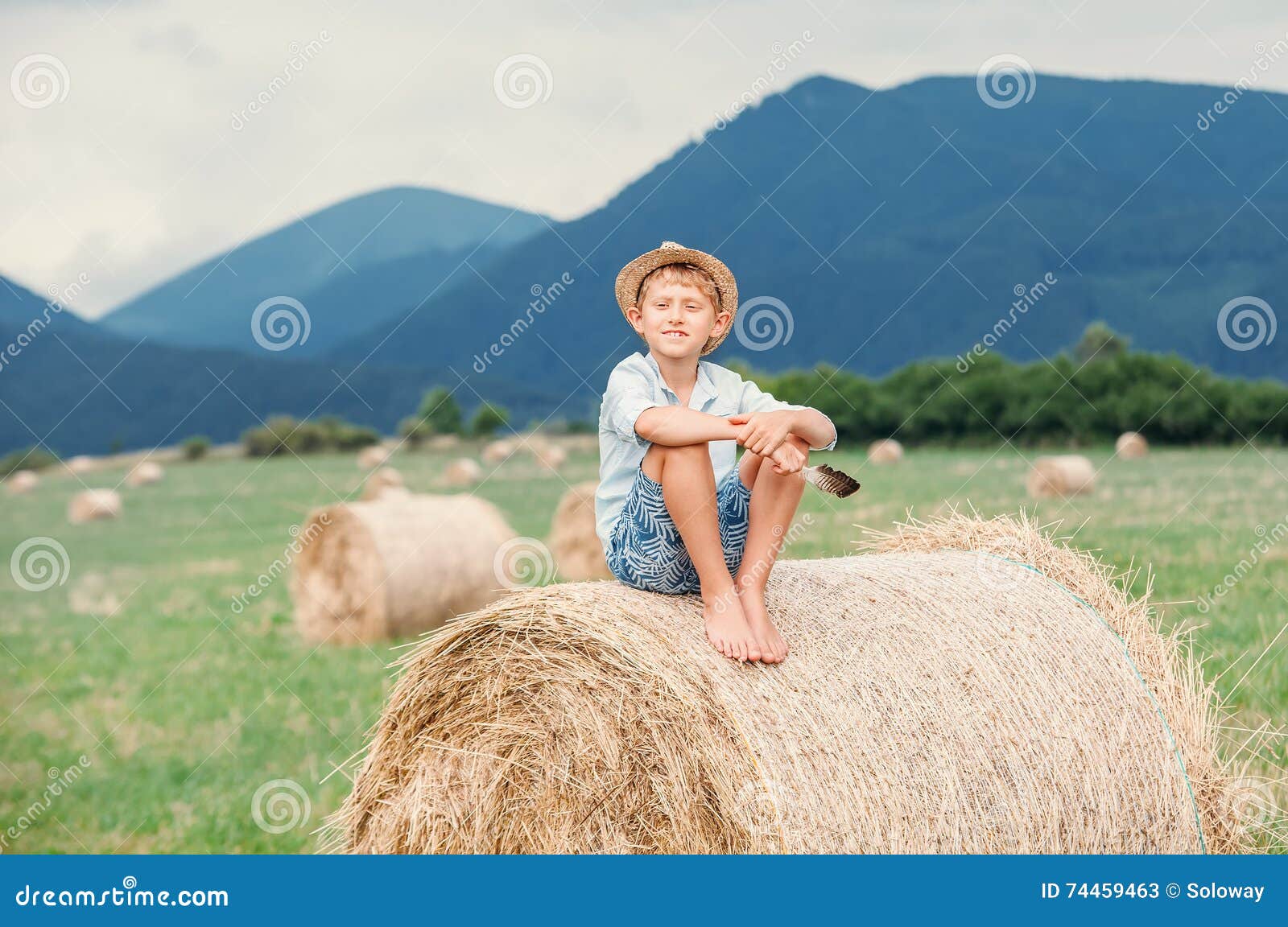 Boy Sits on the Haystack Top Stock Image - Image of health, haystack ...
