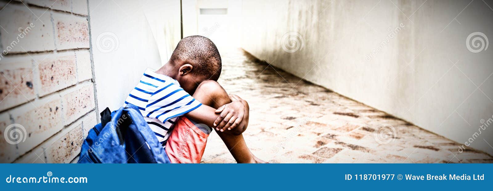 Boy Sitting Alone on School Corridor Stock Image - Image of loneliness ...