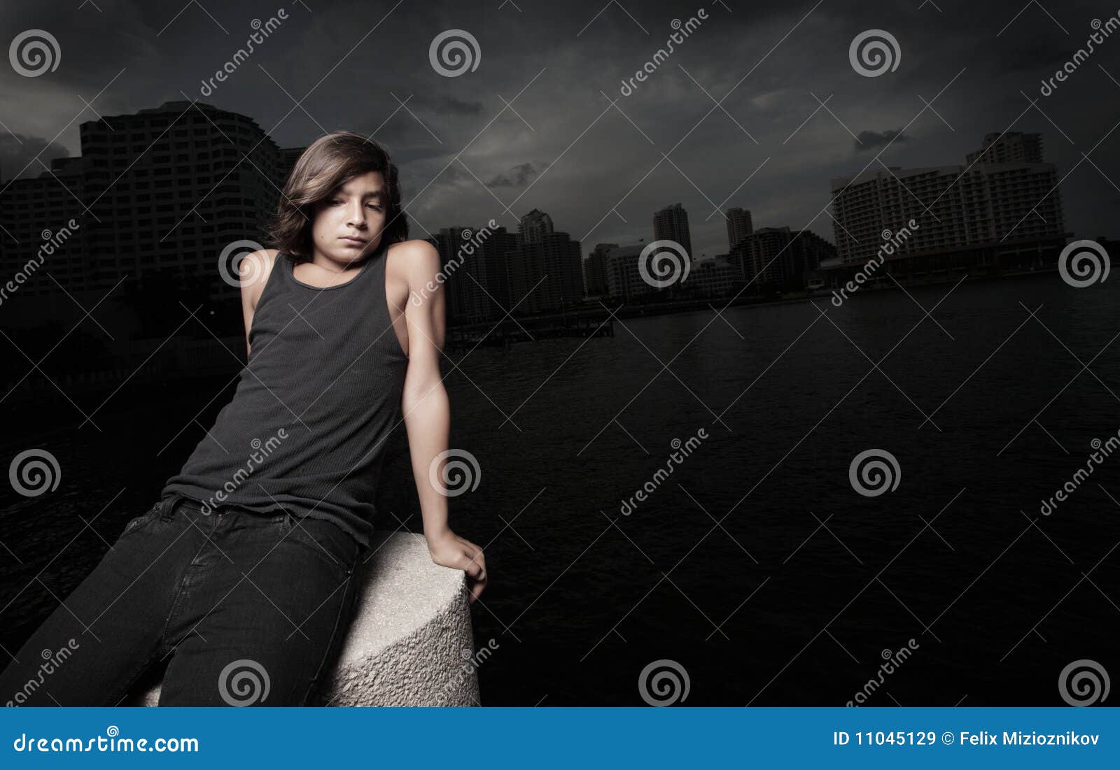 Boy sitting alone at night stock image. Image of lonely - 11045129