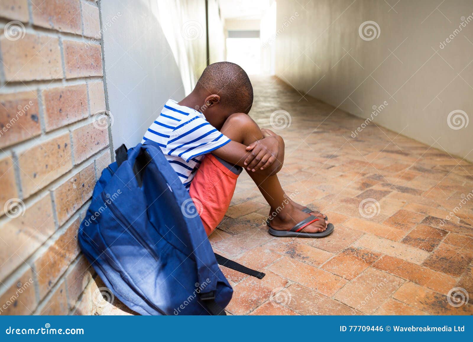 Boy Sitting Alone on School Corridor Stock Photo - Image of school ...