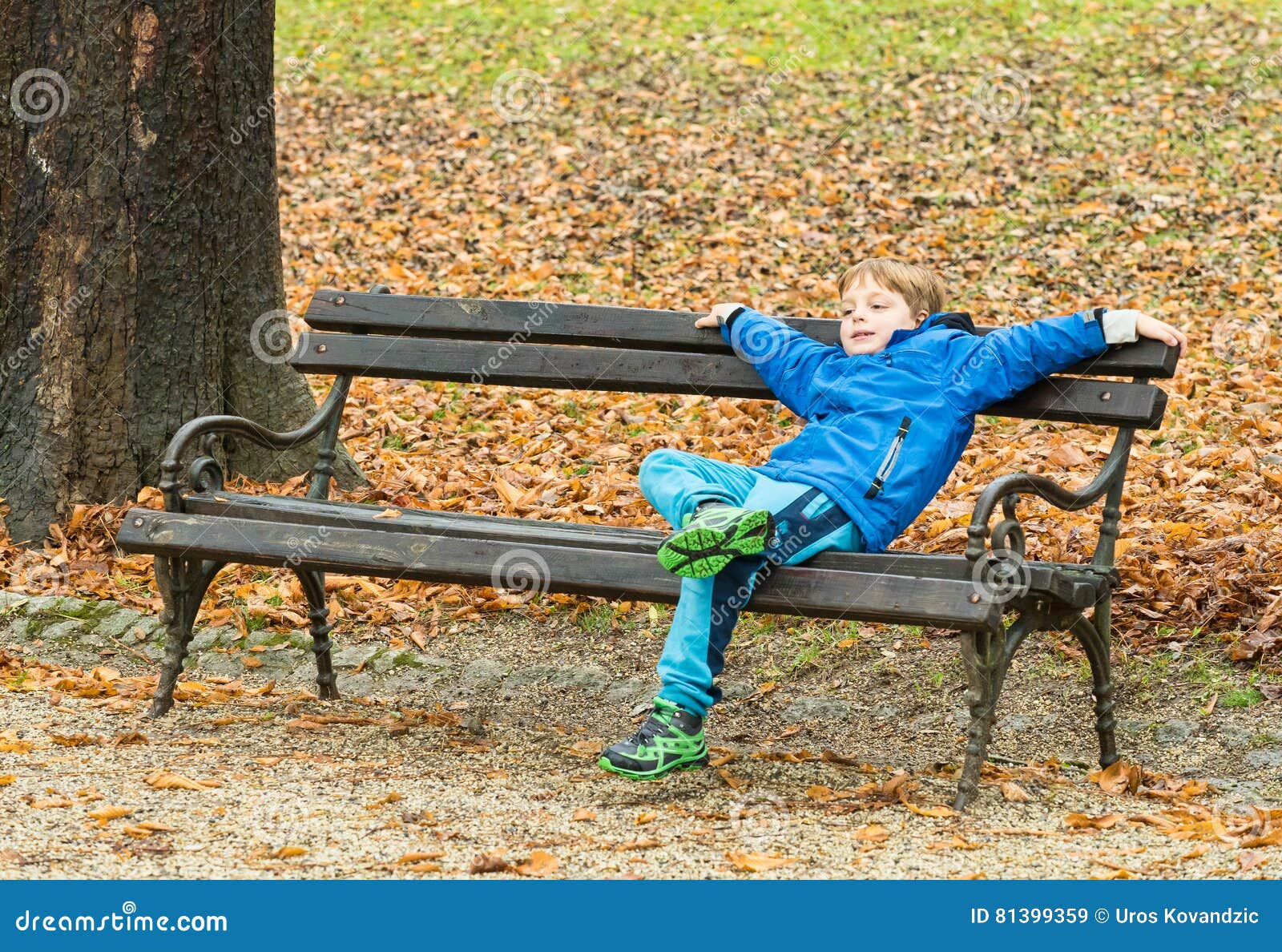 Boy sitting on bench stock image. Image of relaxing, outdoor - 81399359