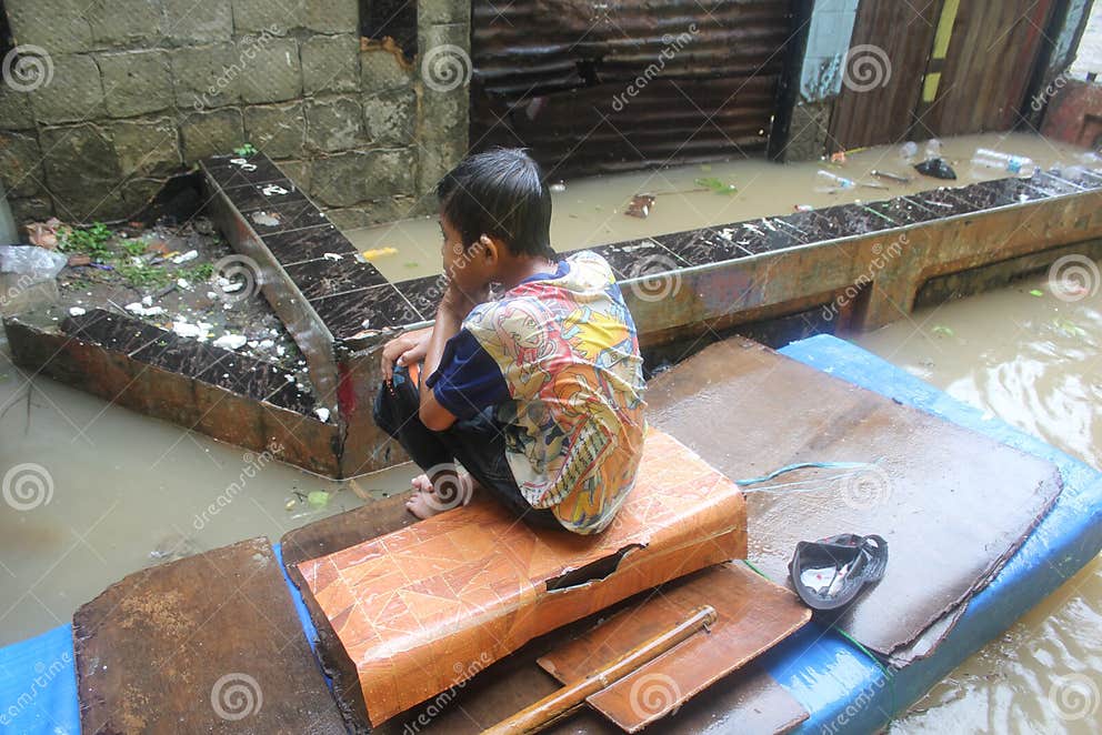 A Boy Sitting on a Boat in the Flood Editorial Stock Image - Image of ...