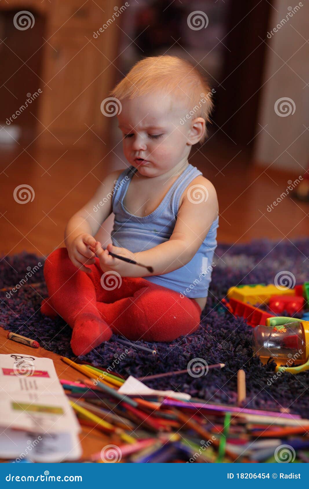 Boy is sitting on carpet stock photo. Image of house - 18206454