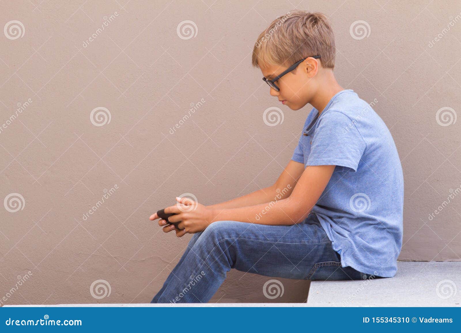 Boy Sitting with Cell Phone and Play Online Games Outdoors Stock Photo ...