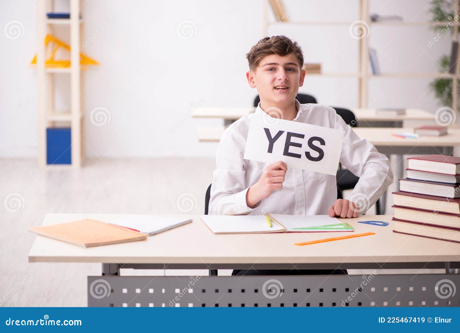 Boy Sitting in the Classrom Stock Image - Image of correct, presenting ...