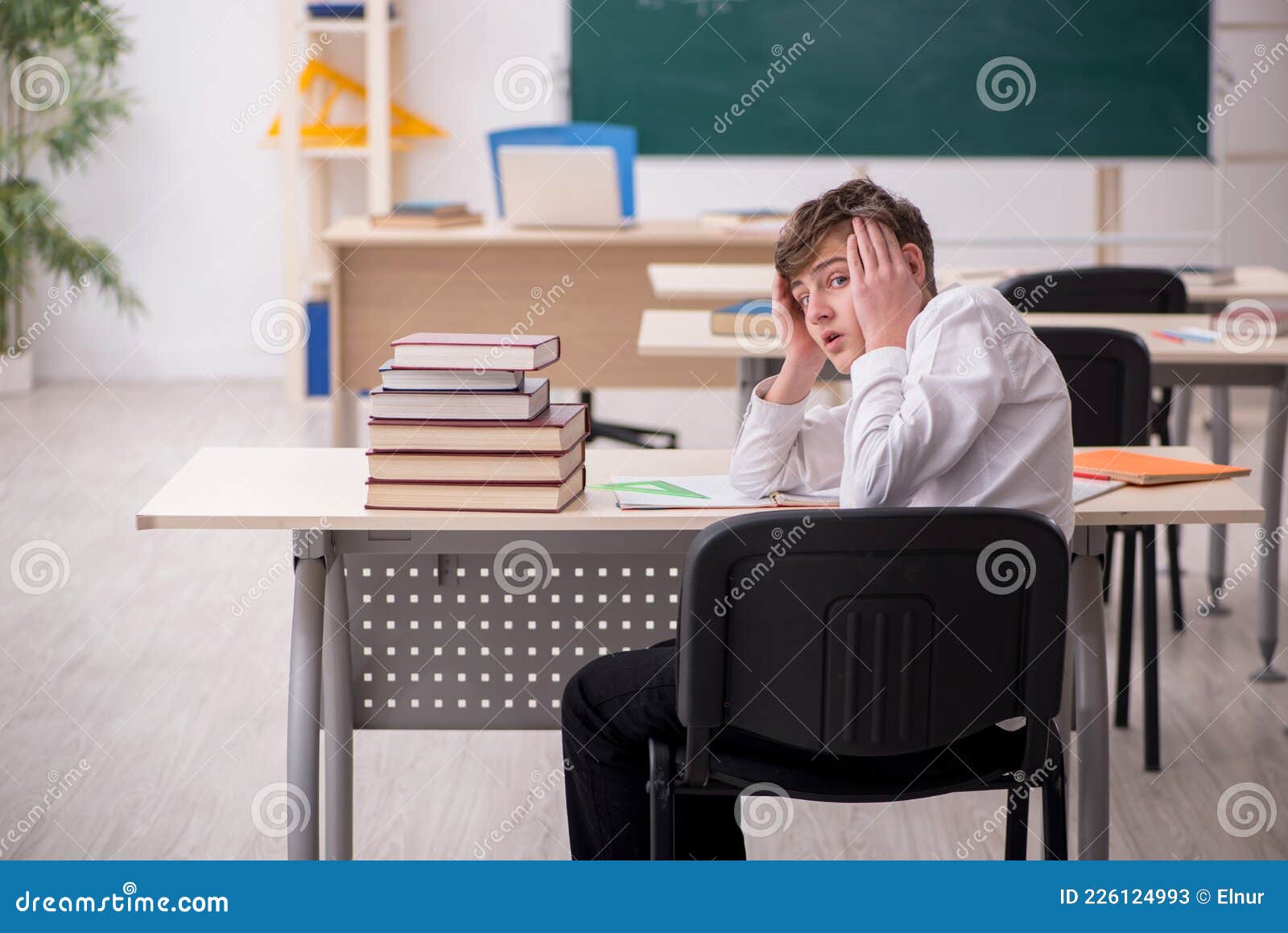 Boy Sitting in the Classrom Stock Image - Image of blackboard ...