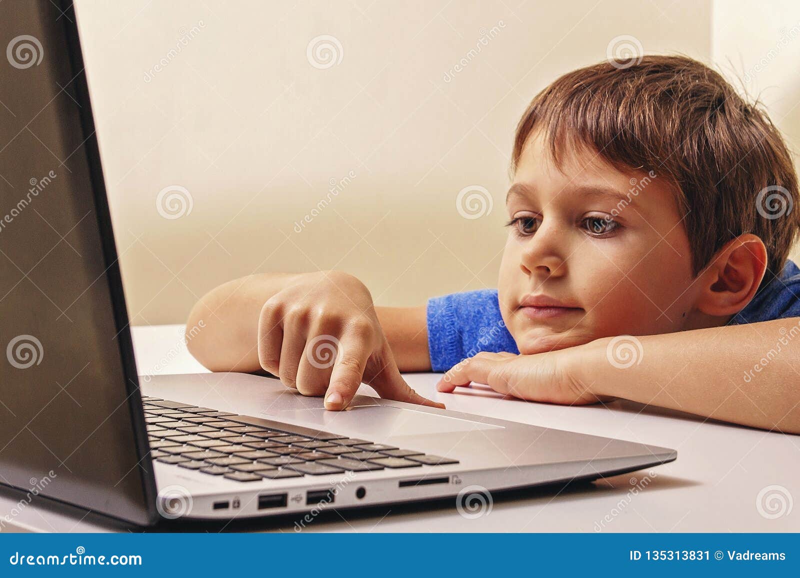 Boy Sitting at Desk with Laptop Computer and Browsing, Watching Video ...
