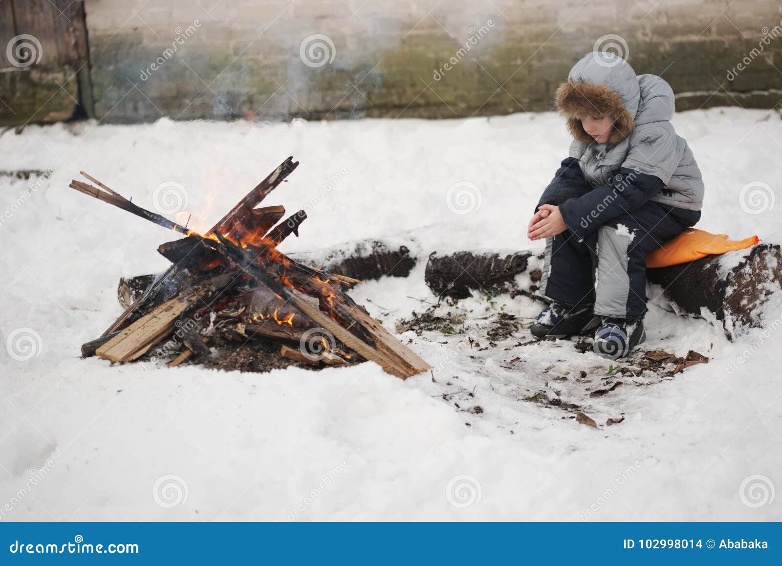 Boy Sitting by Fire in the Street Stock Photo - Image of landscape ...