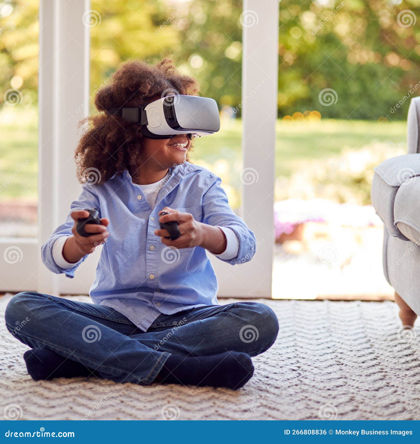 Boy Sitting on Floor in Lounge Wearing VR Headset Playing Game Stock ...