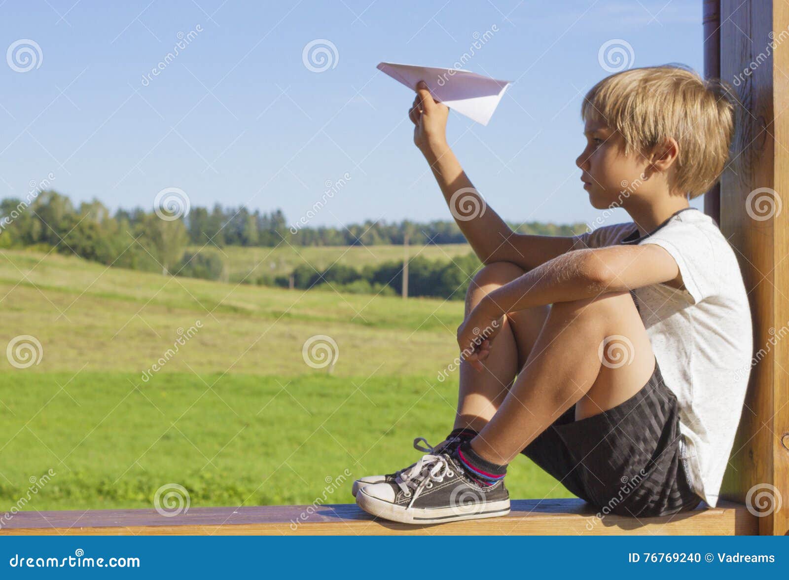 Boy Sitting and Flying a Paper in Summer Day Stock Photo - Image of ...