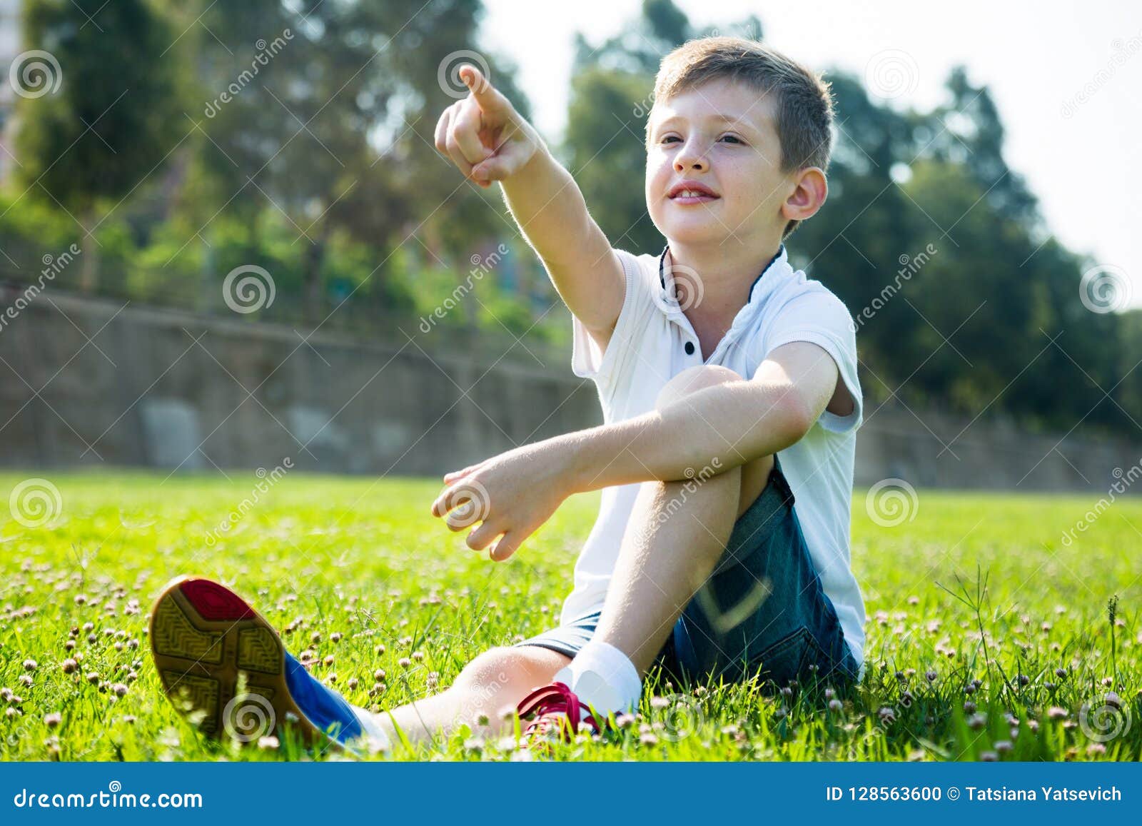 Boy sitting grass stock photo. Image of contemplation - 128563600