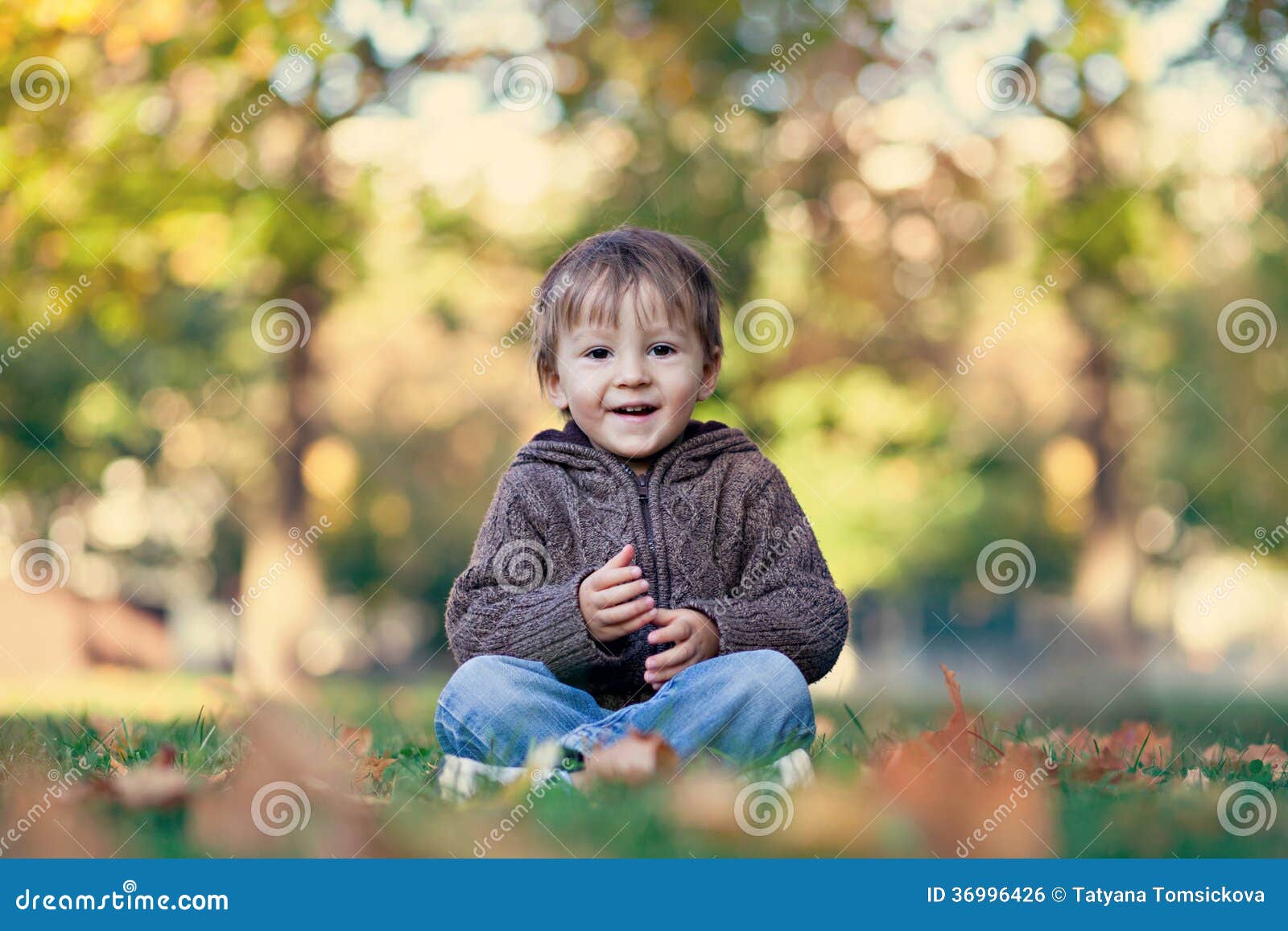 Boy, Sitting on a Lawn, Smiling Stock Photo - Image of relaxation ...