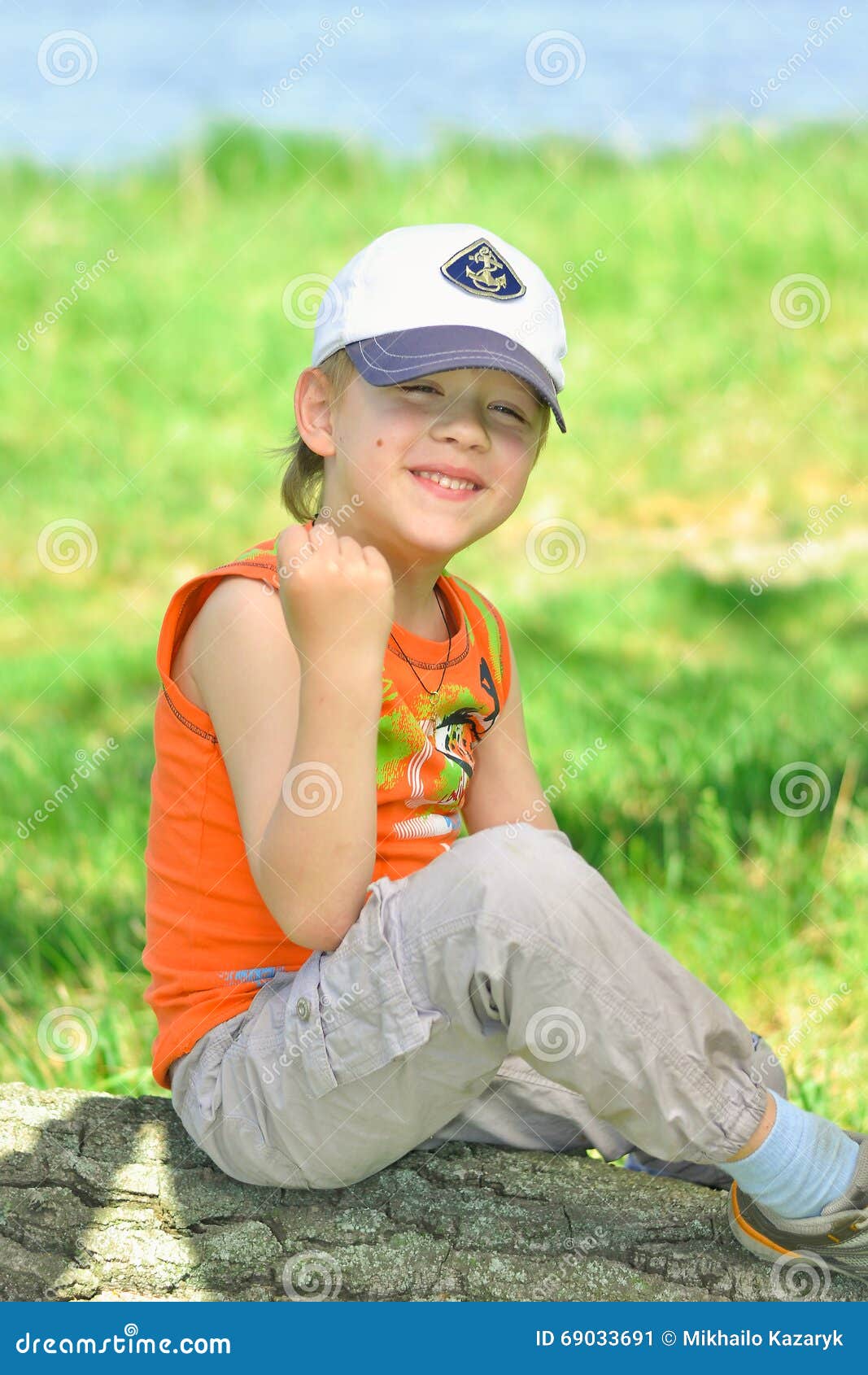Boy Sitting on a Log in Nature Stock Image - Image of candid, water ...