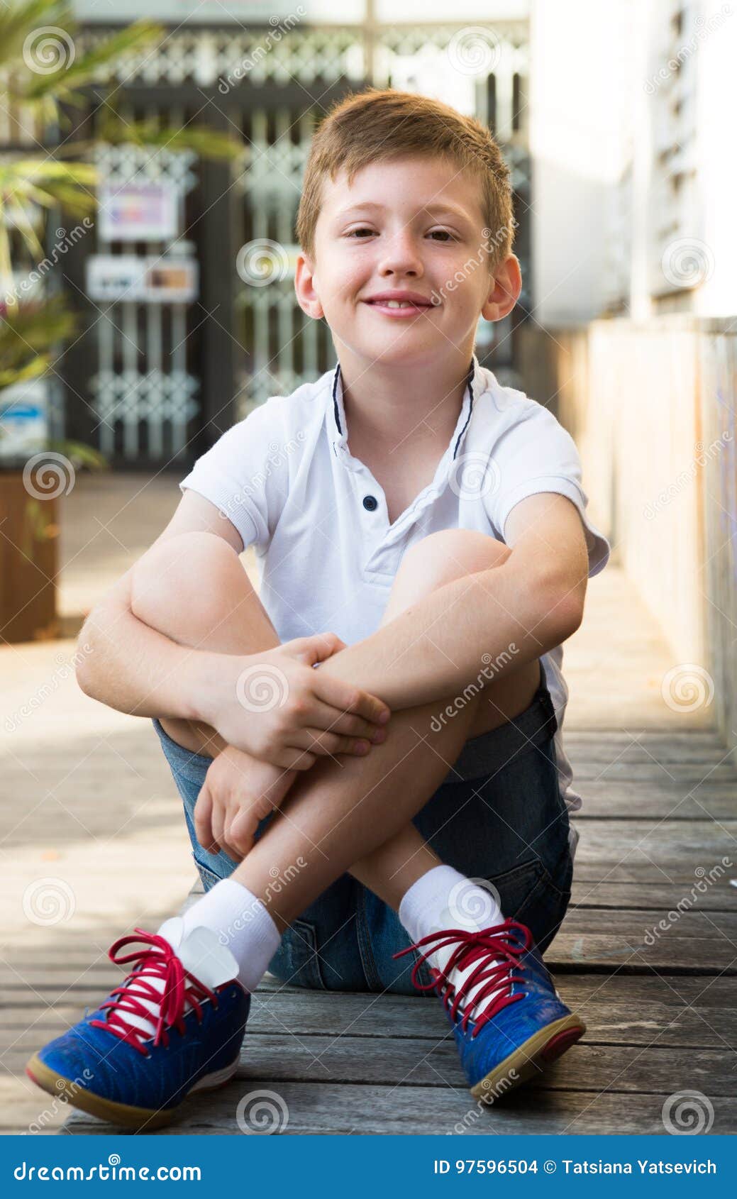 Boy sitting outdoor stock photo. Image of clothing, park - 97596504