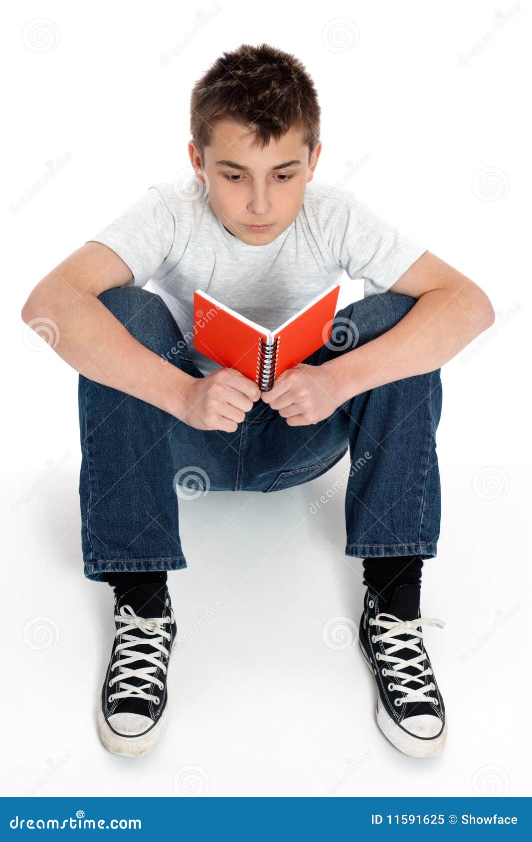 Boy Sitting Reading Notebook Stock Image - Image of jeans, people: 11591625
