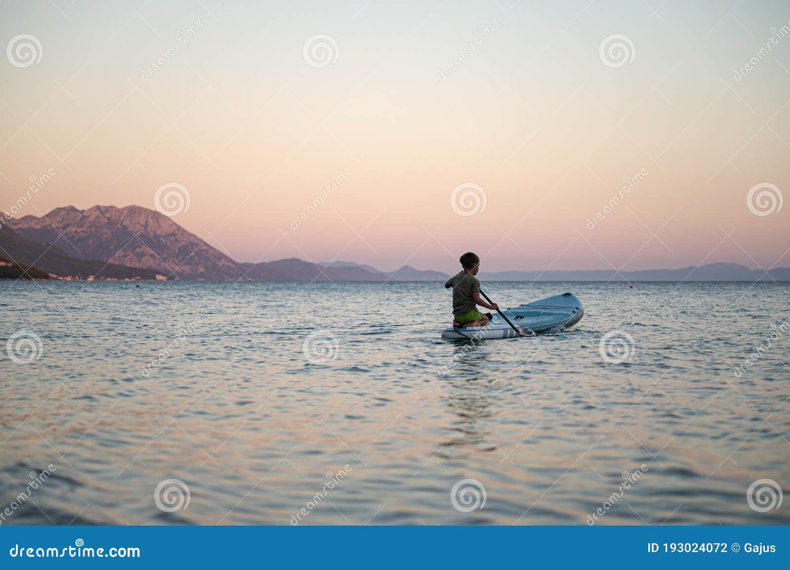 Boy Sitting on the Rear End of Sup Board Stock Photo - Image of ...