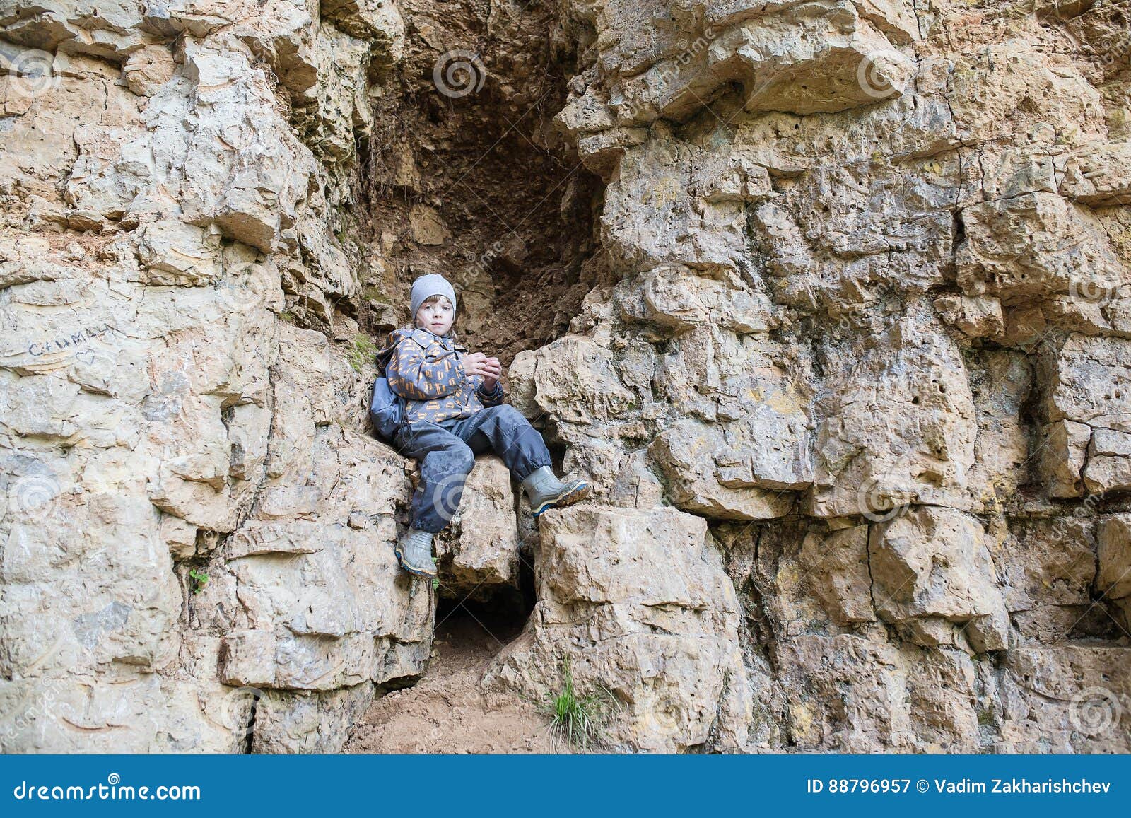 Boy sitting on the rock stock image. Image of happiness - 88796957