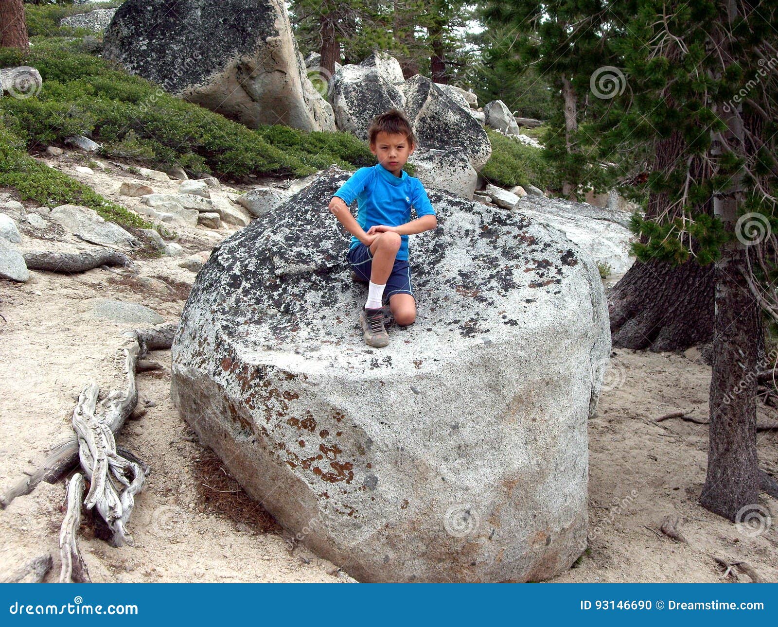 Boy sitting on rock stock photo. Image of serious, grey - 93146690