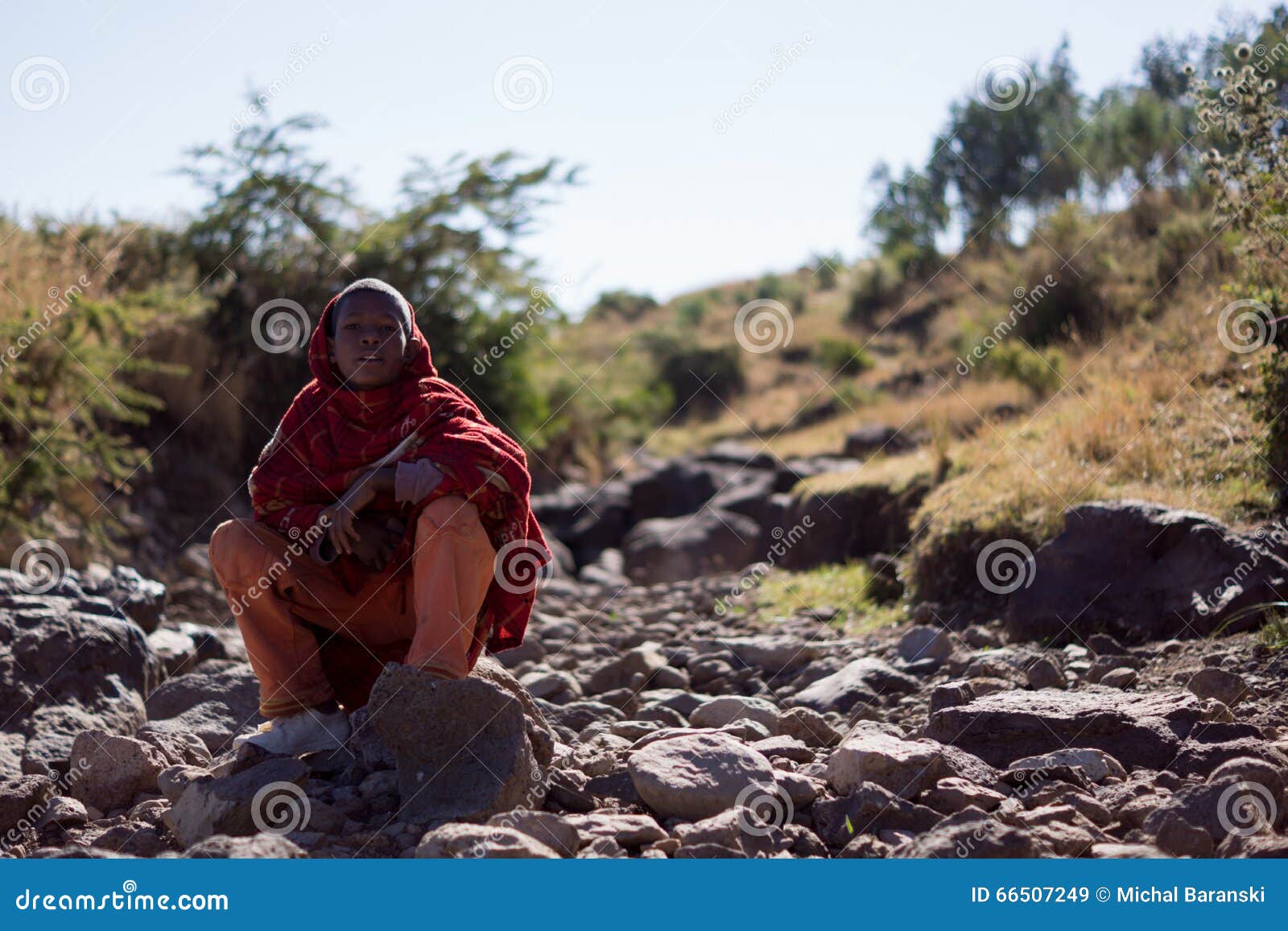Boy sitting on rocks editorial stock image. Image of stream - 66507249