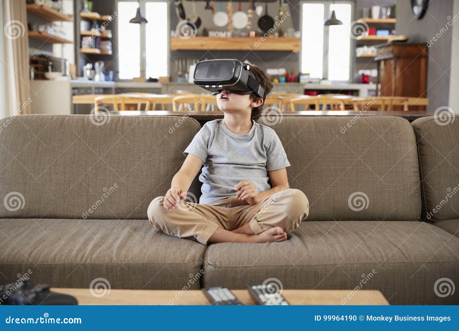 Boy Sitting on Sofa Wearing Virtual Reality Headset Stock Photo - Image ...