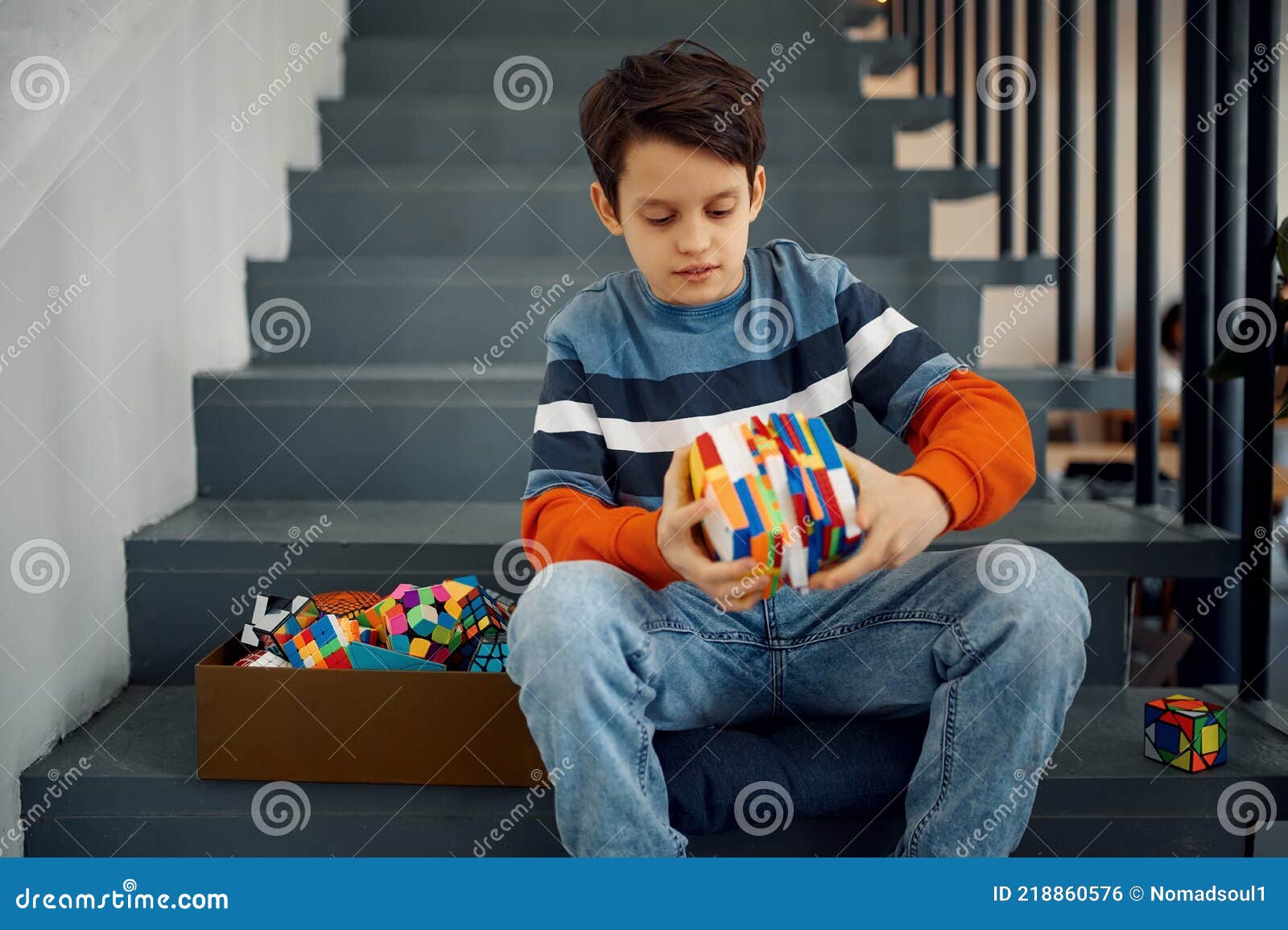 Boy Sitting on Steps and Play with Puzzle Cubes Editorial Photo - Image ...