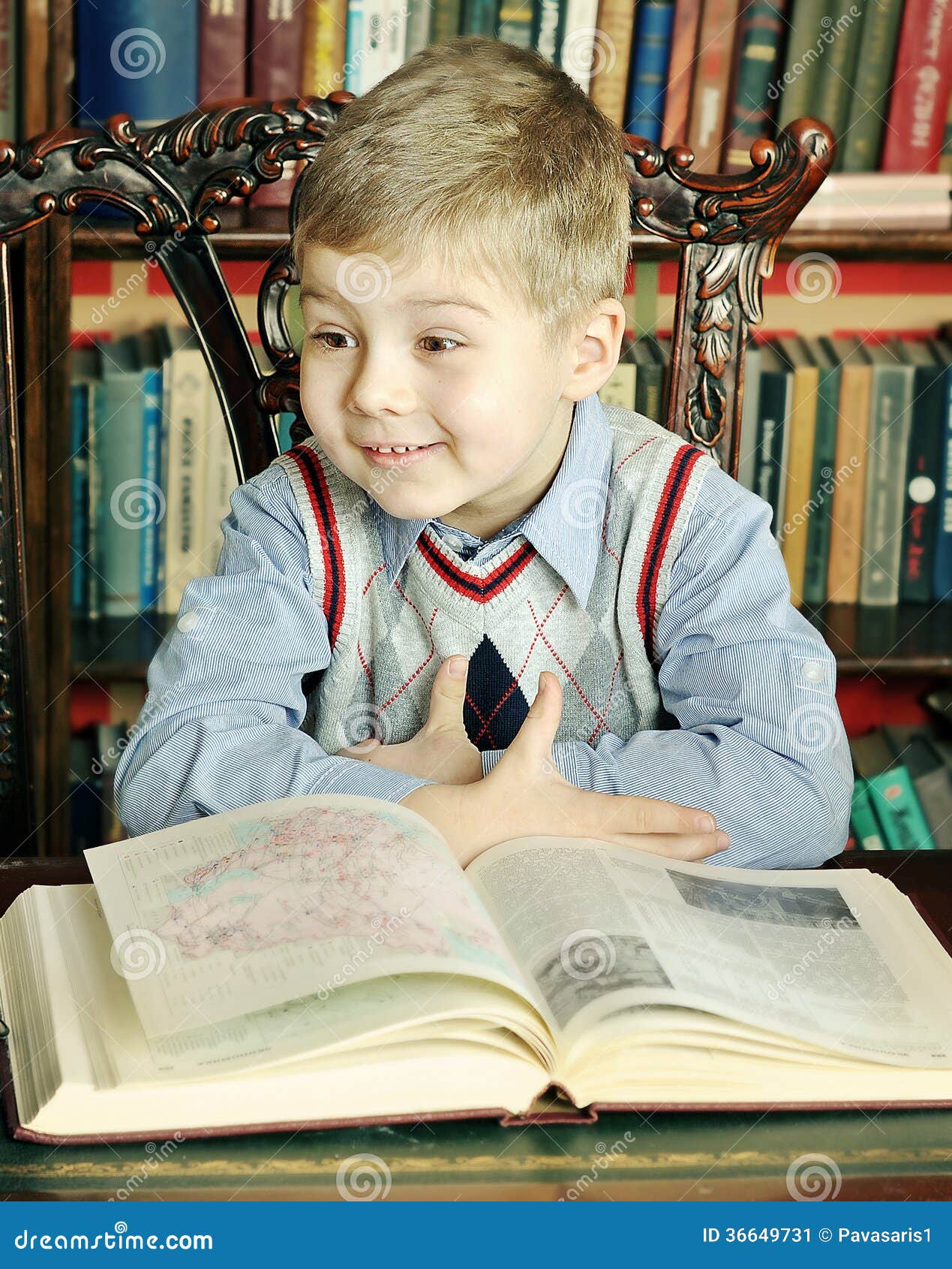 Boy Sitting at a Table with a Big Book Stock Image - Image of ...