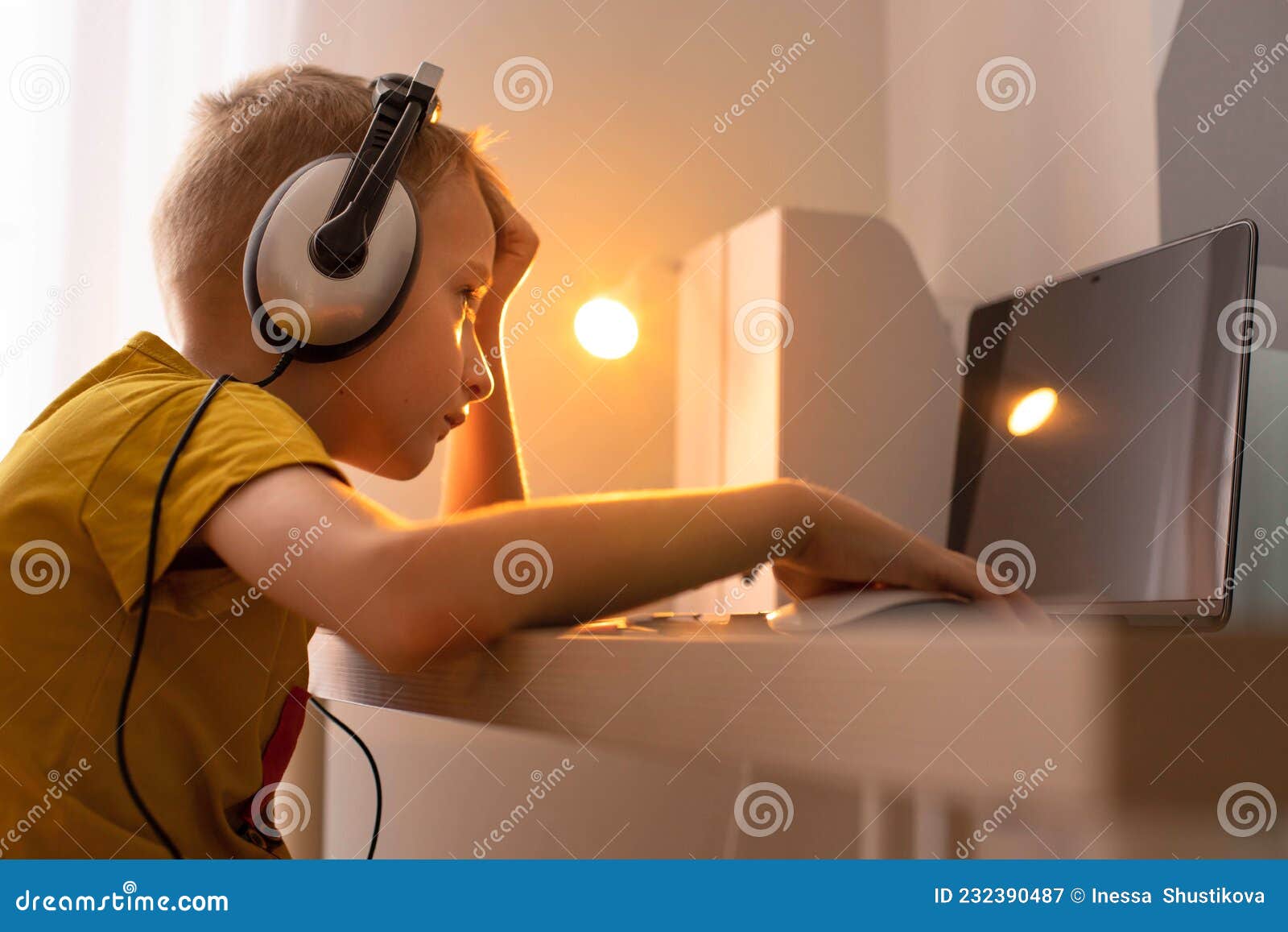 The Boy is Sitting at the Table in the Children`s Room and Playing ...