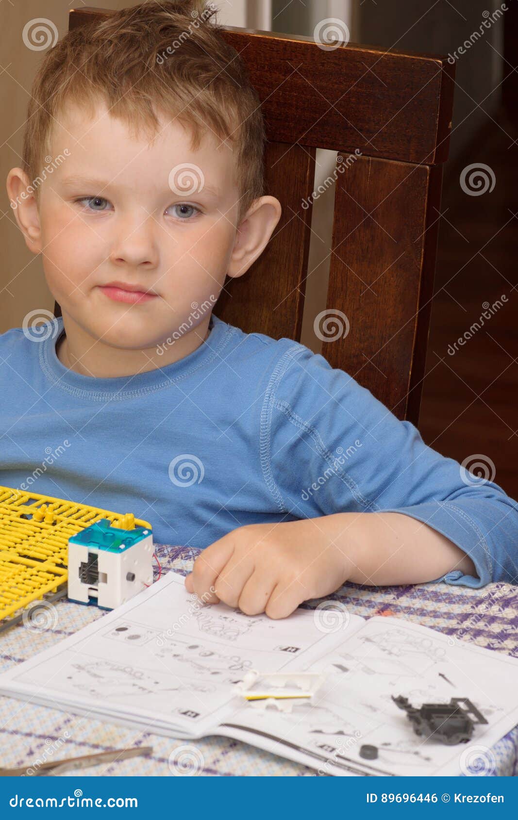 Boy sitting at the table stock photo. Image of children - 89696446