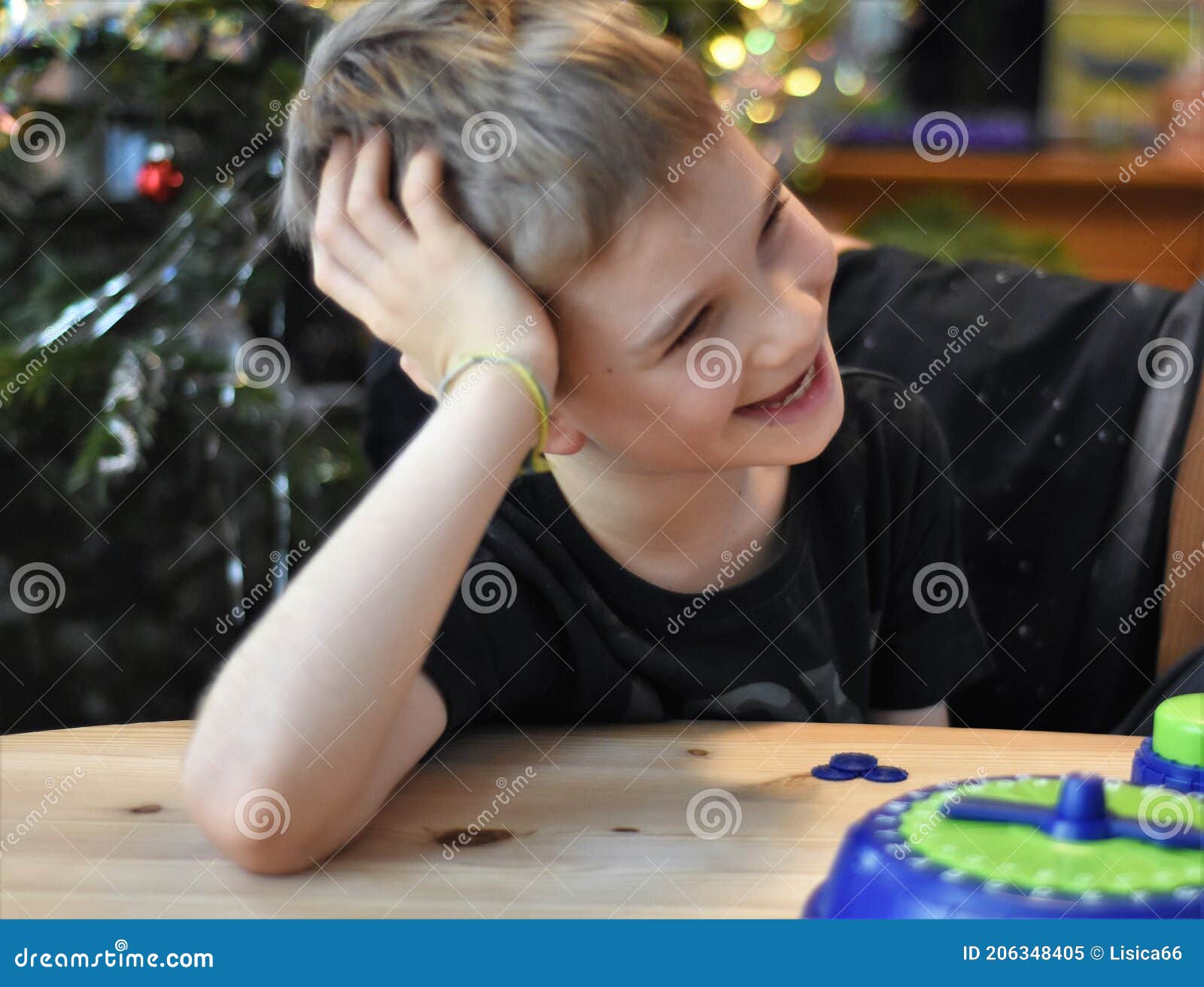 Joyful Boy Sitting at a Table with a Game Stock Image - Image of ...