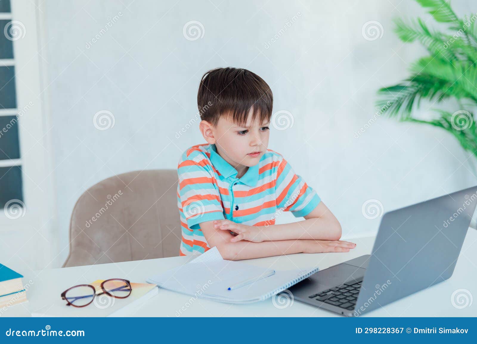 Boy Sitting at Table Looking at Laptop Stock Image - Image of study ...