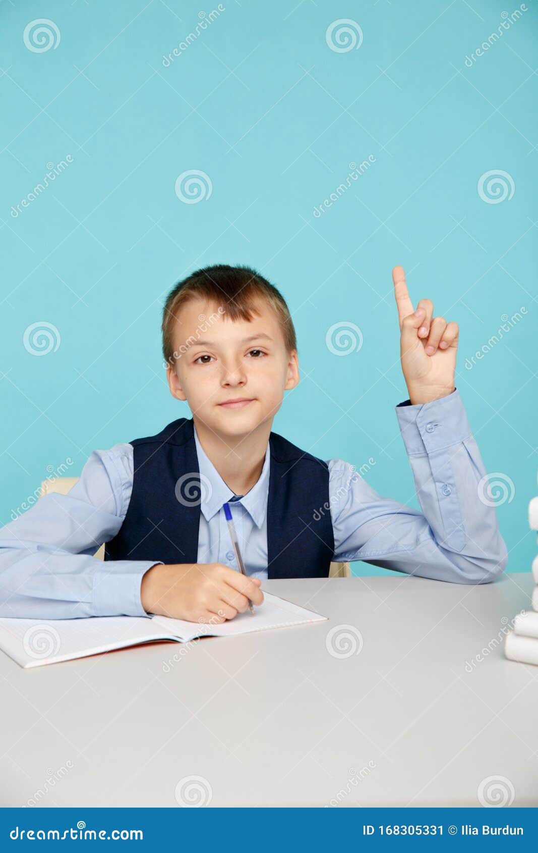 Boy Sitting at the Table and Pointing Something Up. Stock Image - Image ...