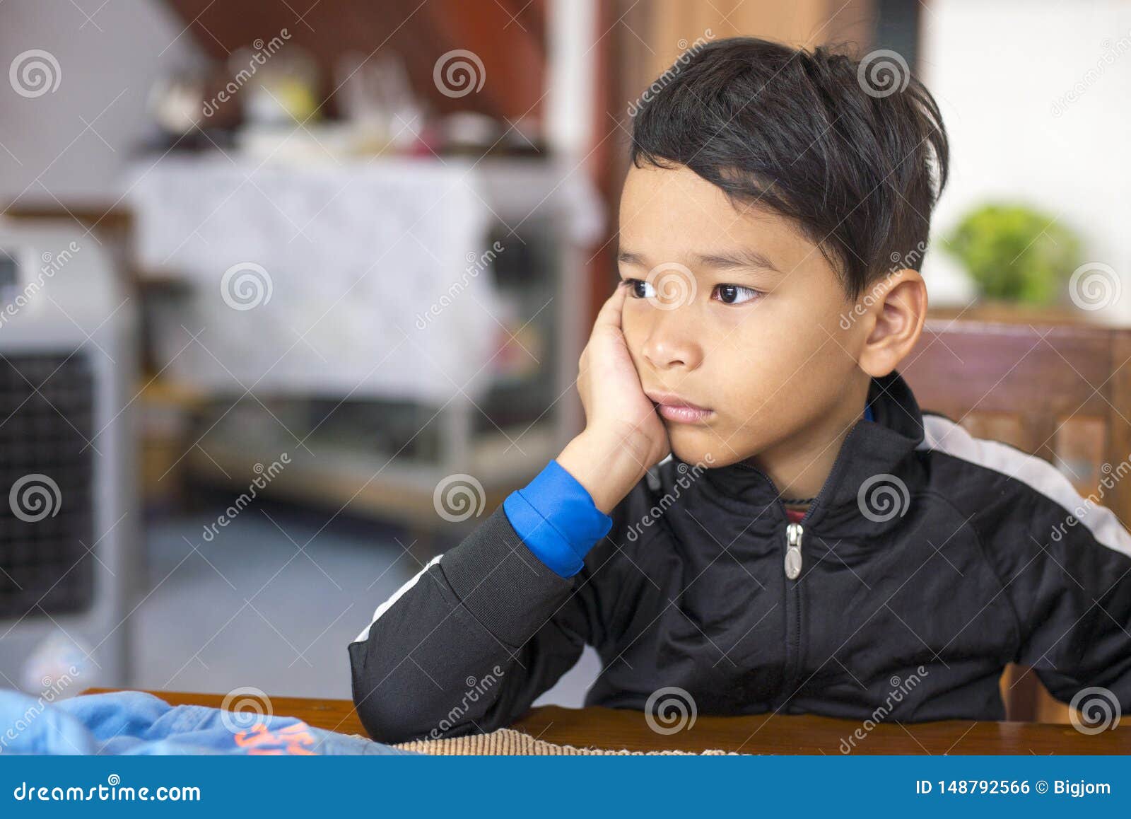Boy Sitting on the Table, Thinking about Something. Stock Photo - Image ...