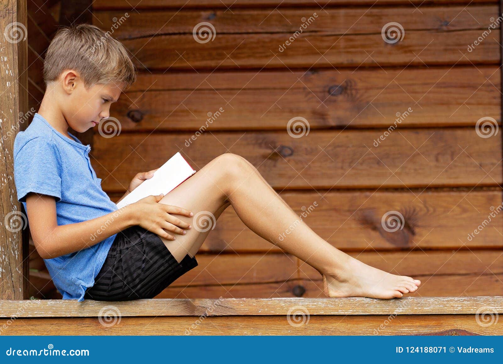 Boy Sitting in Terrace and Reading Book Outdoor Stock Image - Image of ...