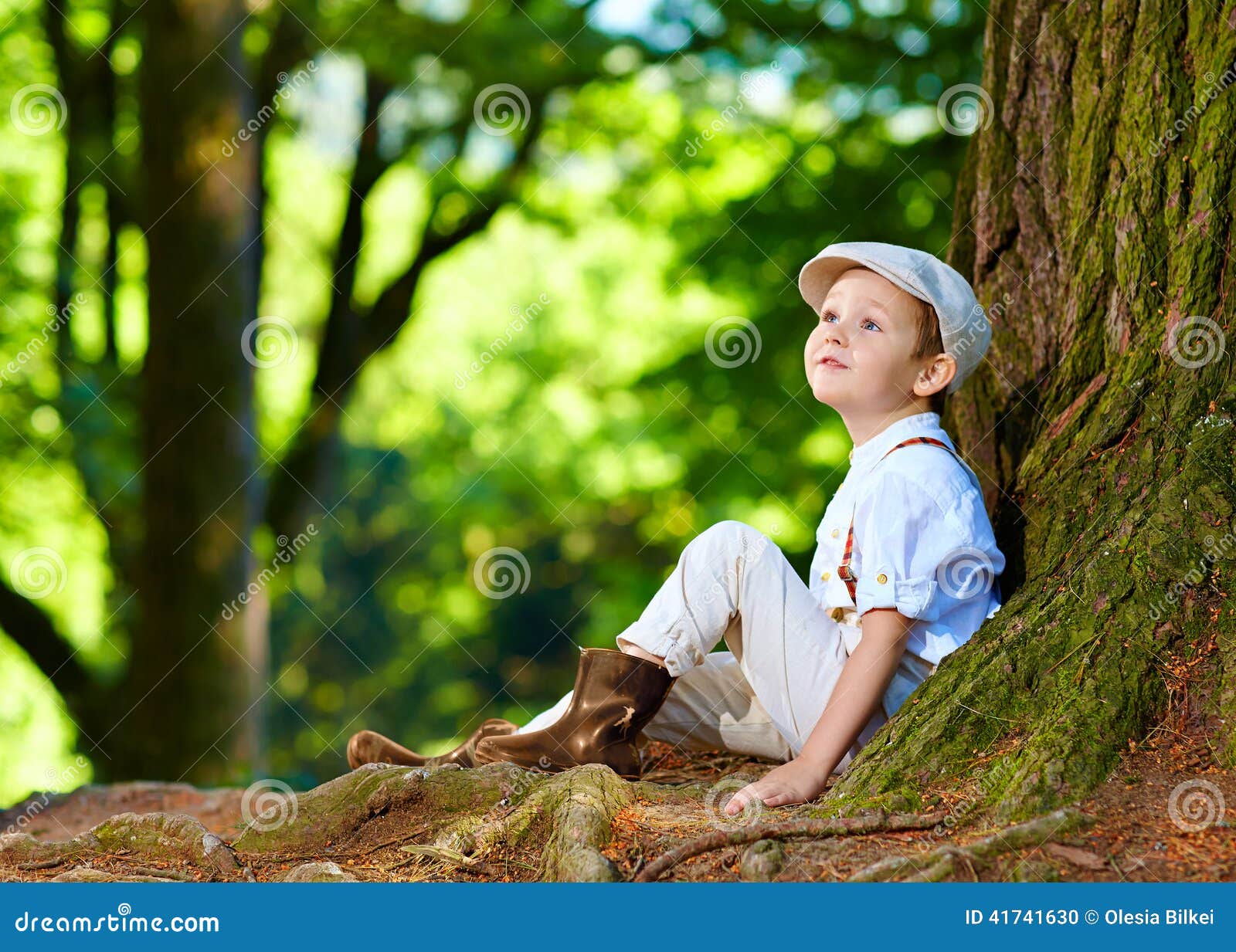 Boy Sitting Under an Old Tree, in the Forest Stock Photo - Image of ...