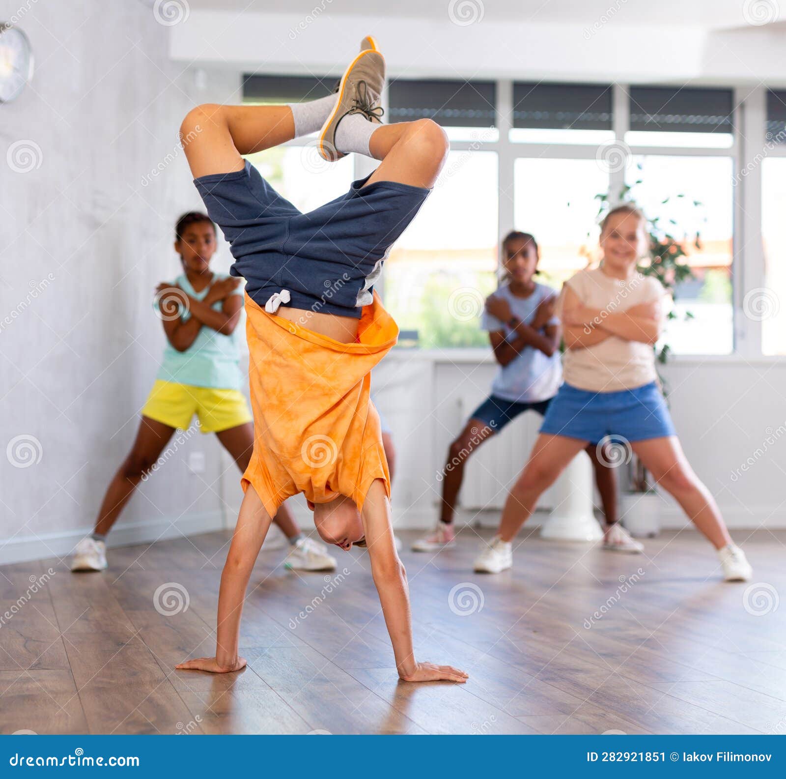 Boy Performs Handstand during Break Dance Workout with Peers Friends ...