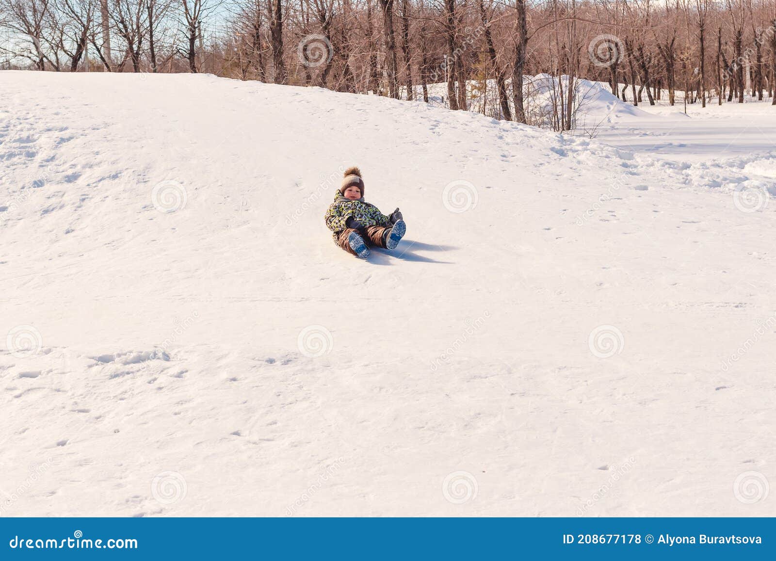 Boy on Sled Ice Rides from the Hill in Winter Stock Photo - Image of ...