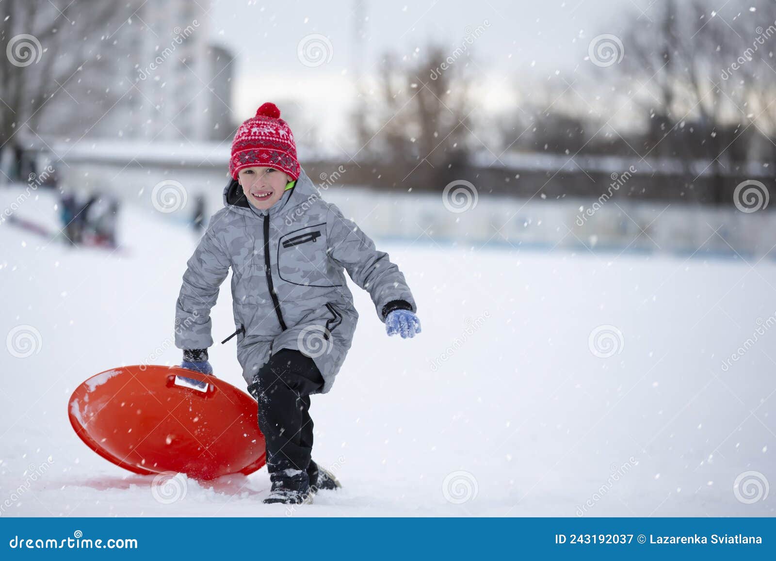 The boy is sledding stock image. Image of mountain, play - 243192037