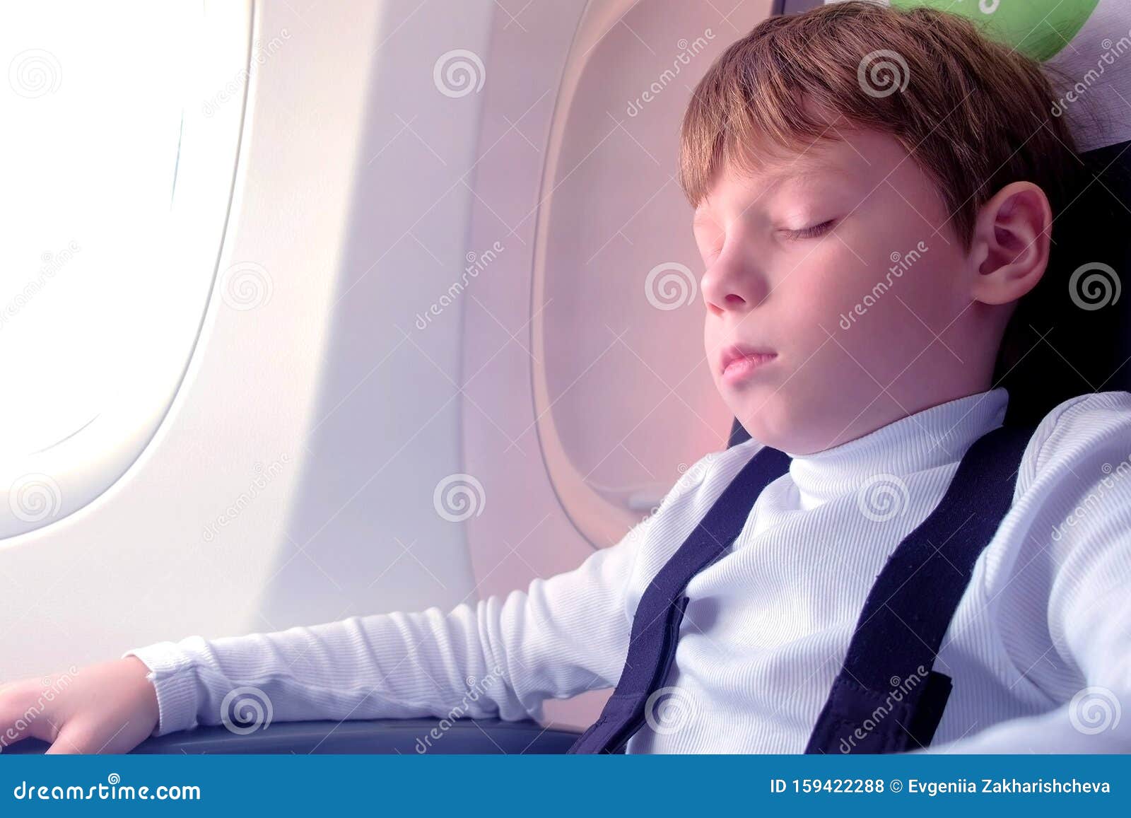 Boy Sleeps on a Plane Next To the Window. Side View. Stock Photo ...