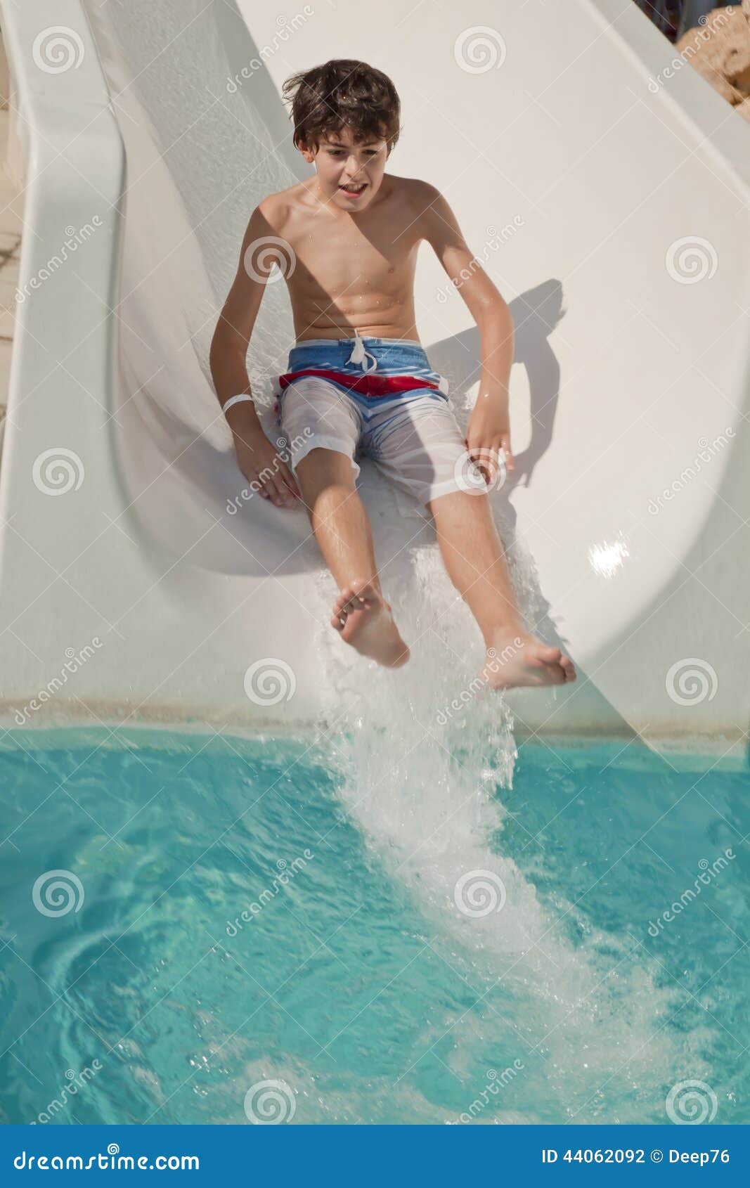 Boy on slide at waterpark stock photo. Image of swim - 44062092
