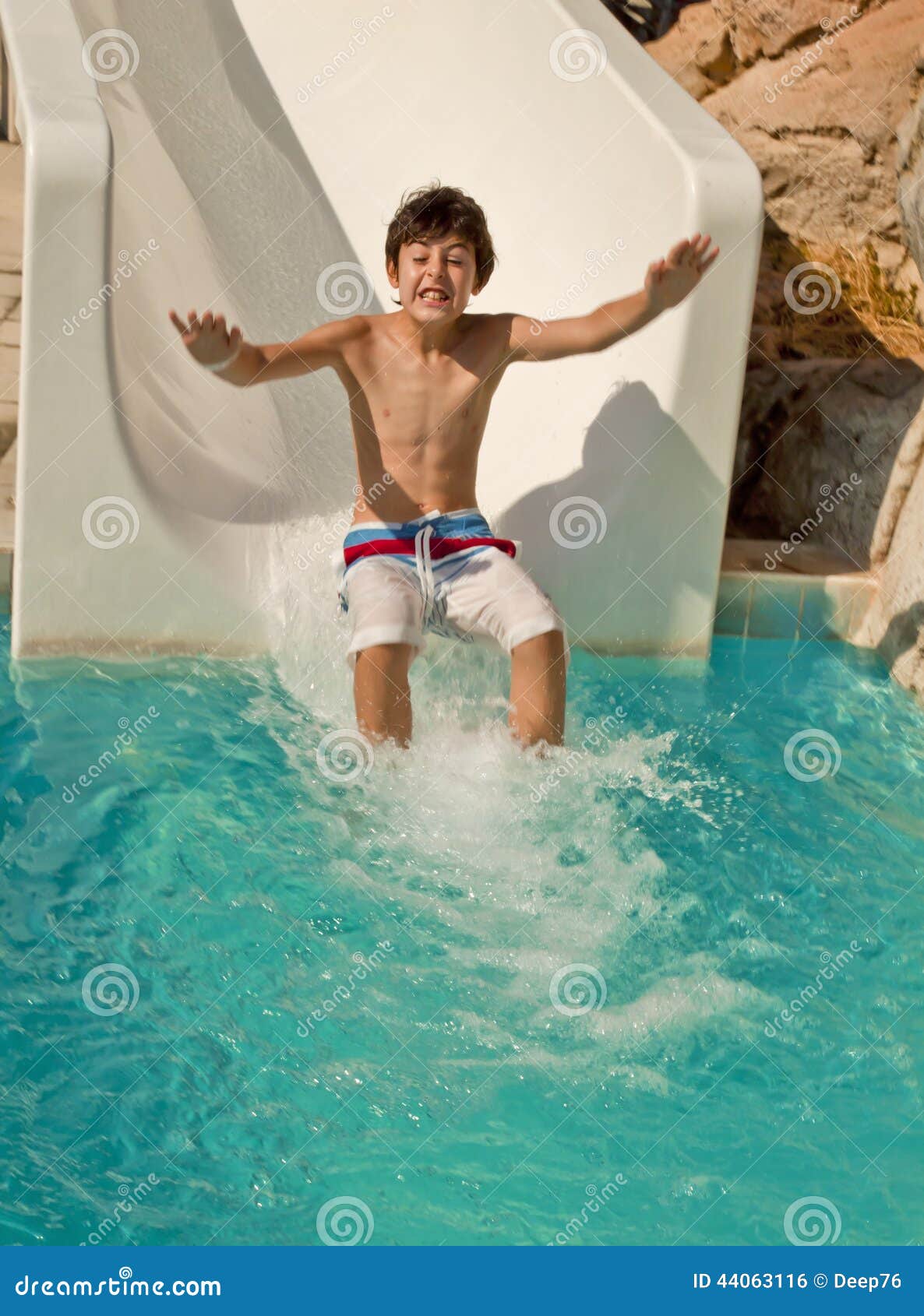 Boy on slide at waterpark stock photo. Image of rock - 44063116