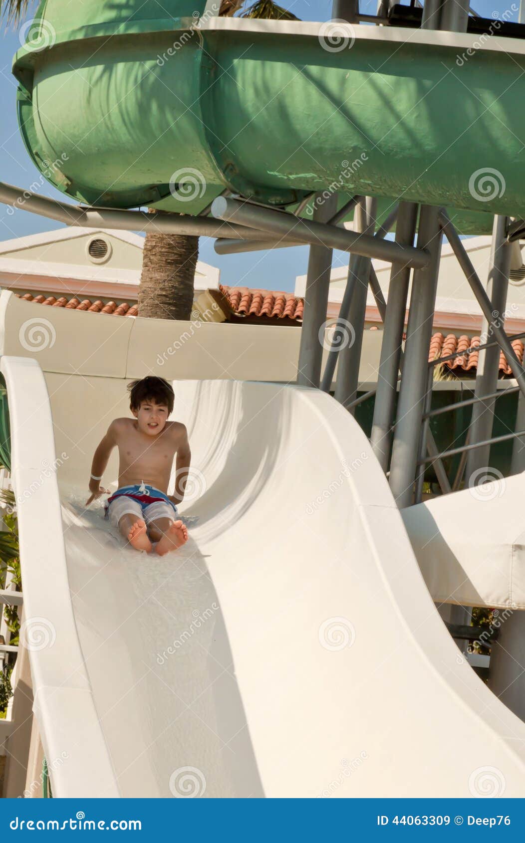 Boy on slide at waterpark stock image. Image of vacation - 44063309